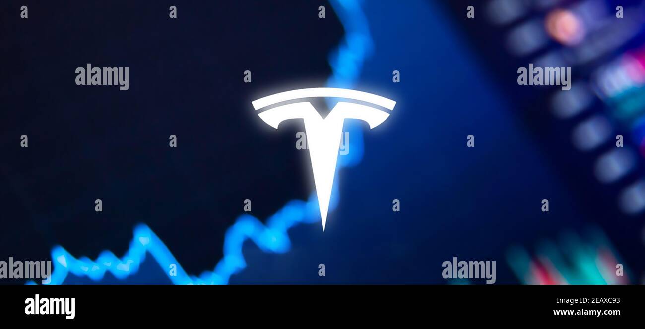 The Tesla logo on the background of the growth of the companys shares ...