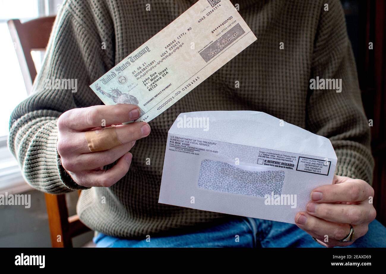 A man opens a check for economic relief during the covid 19 pandemic ...