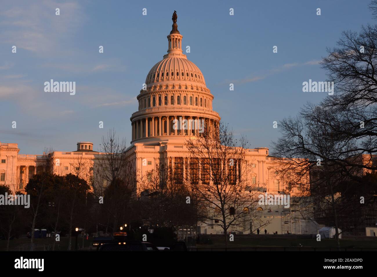 Orange glow sunset at US Capitol building in Washington DC. Blue sky ...