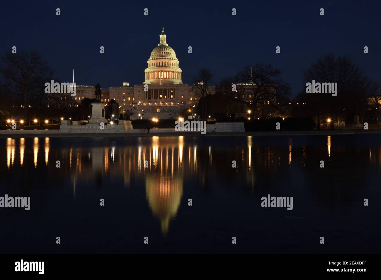 US Capitol building at night with light reflection on the Capital ...