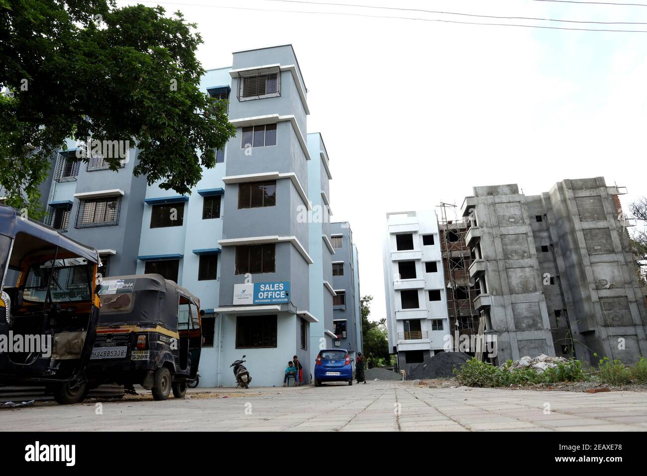 A ground level view of a completed apartment and a under construction ...