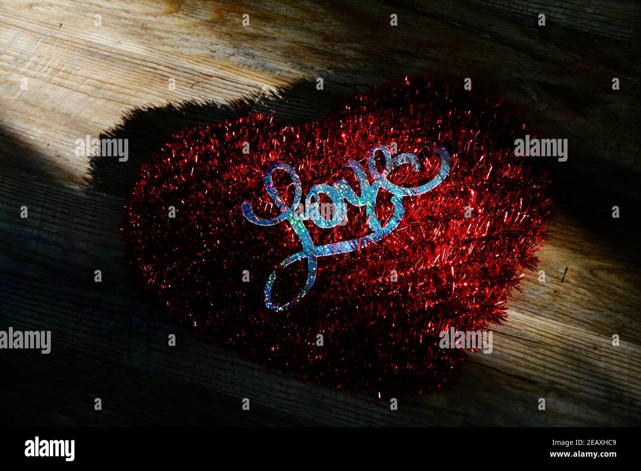 A red heart with the word love written on it with exposed by a small ...