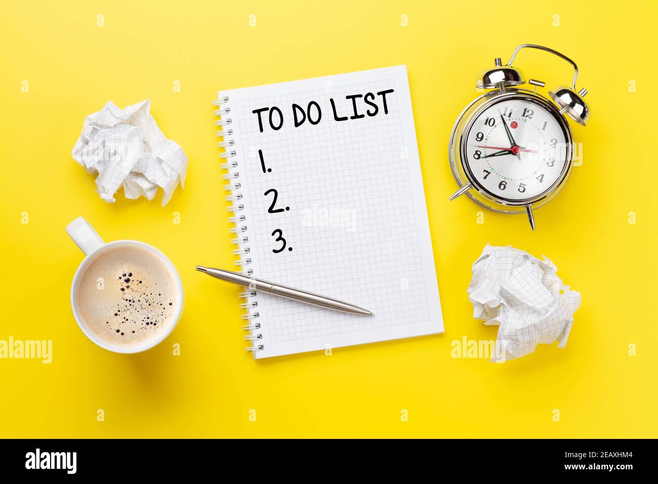 Office desk with coffee, alarm clock and notepad with to do list over ...