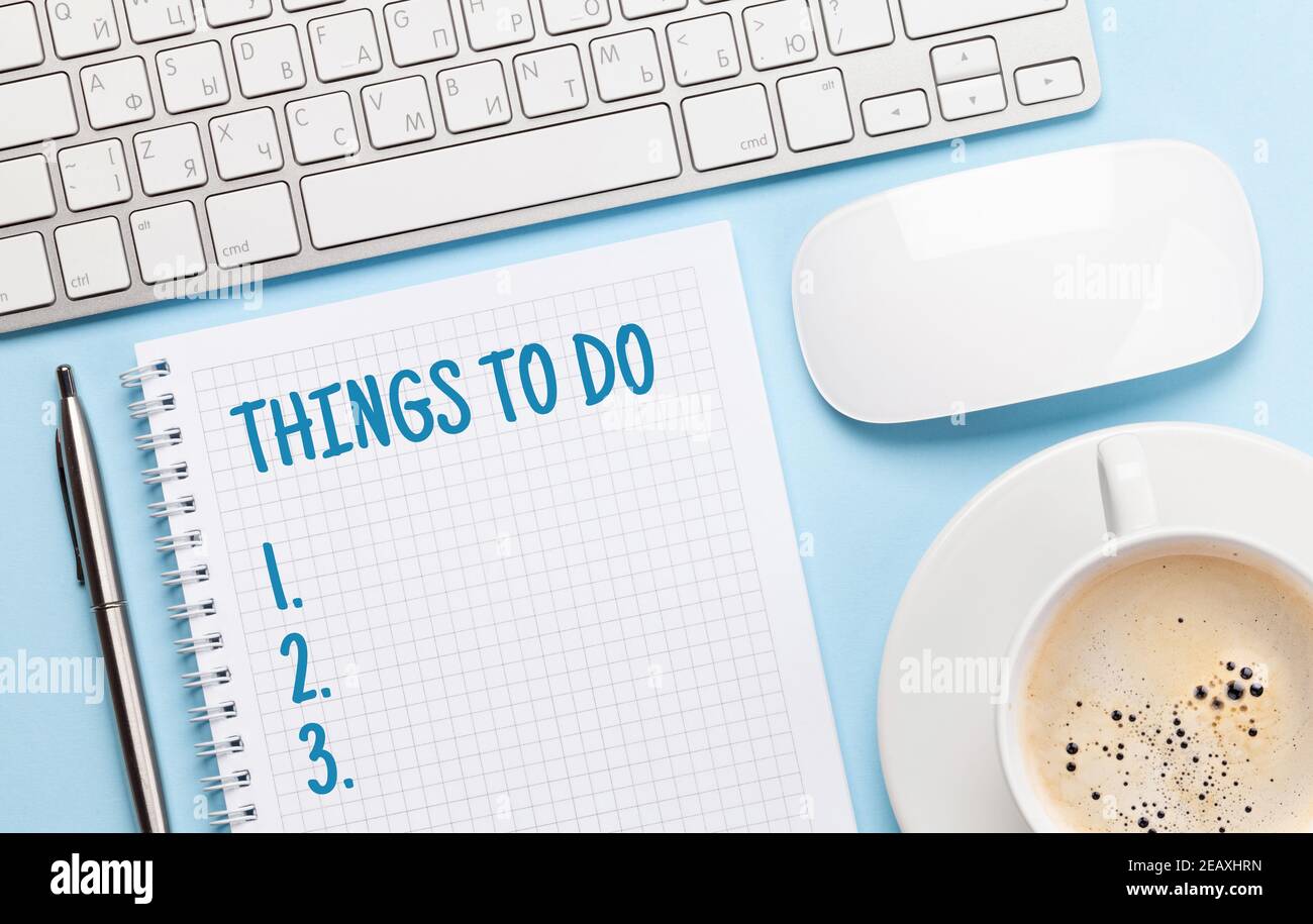 Blue workplace desk table with to do list, computer, supplies and ...