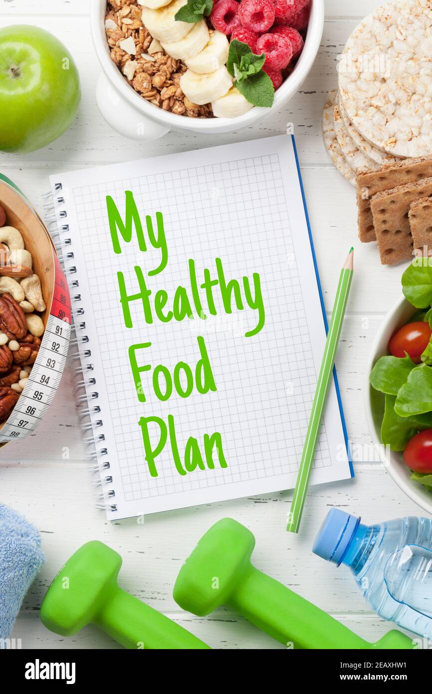 Healthy food and fitness concept. Various nuts, cereal, salad and ...