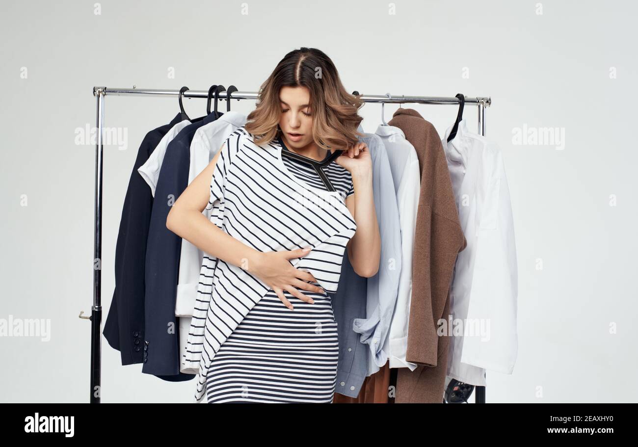 Woman trying on fashionable clothes in a shop shopping style shirt ...