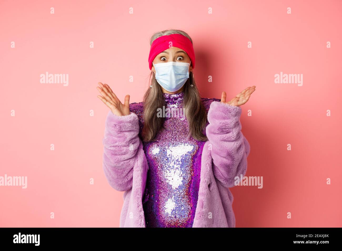 Covid-19, social distancing and fashion concept. Surprised asian senior ...