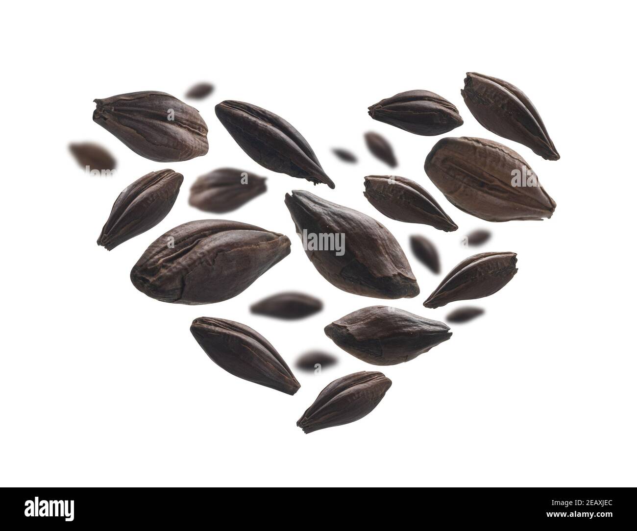 Roasted rye malt grains in the shape of a heart on a white background ...