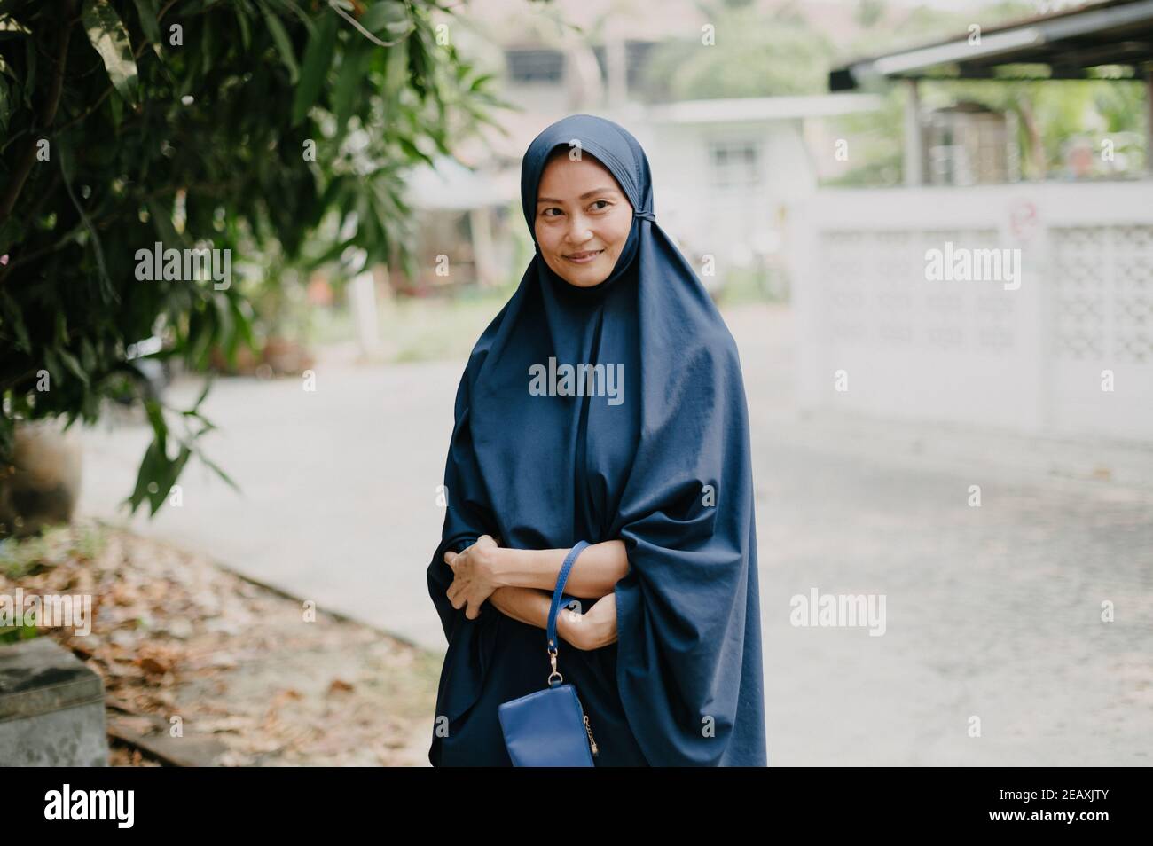 Thai Muslim womam wearing a blue hijab dress, smiling Stock Photo - Alamy