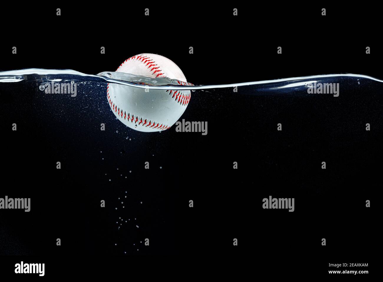 Baseball ball floating in the water against black background Stock ...