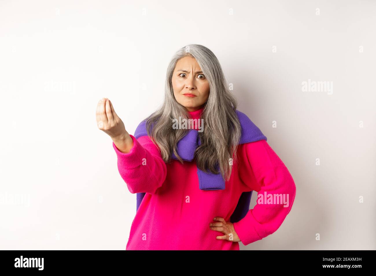 Funny asian woman staring angry and confused, shaking fingers, standing ...
