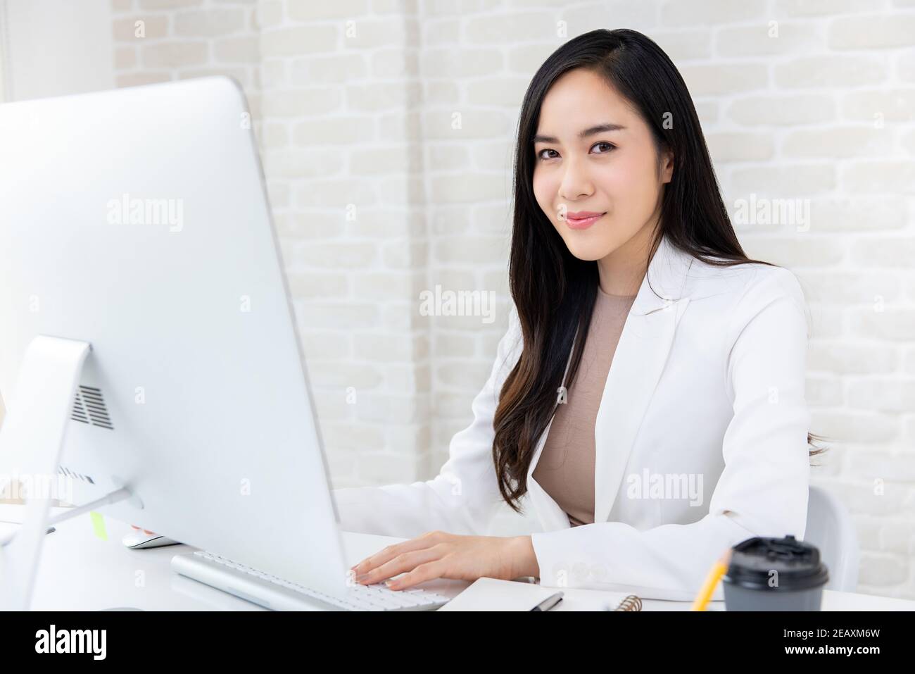 Attractive smart happy Asian businesswoman working in the office Stock ...