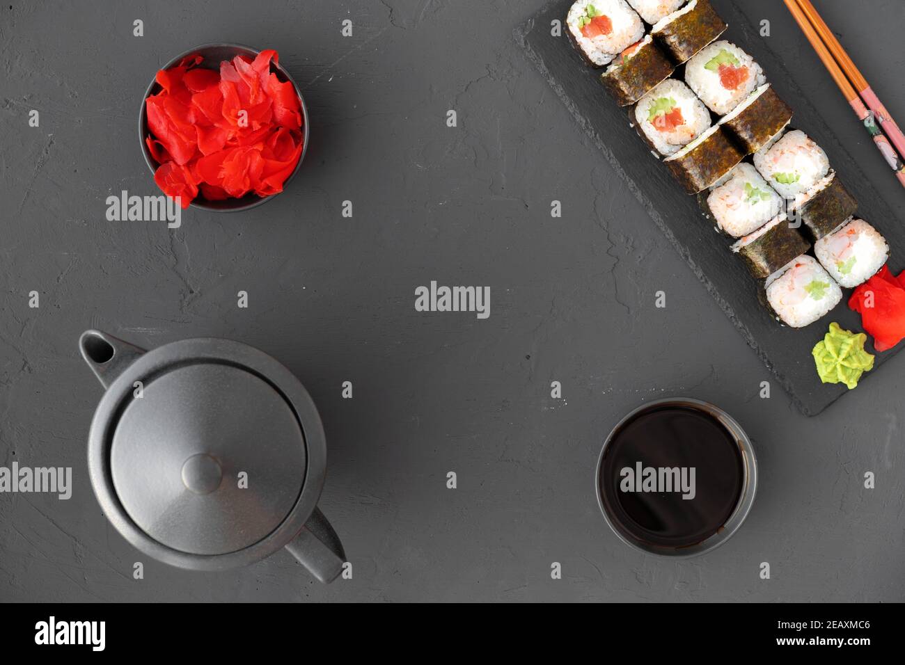 Maki sushi on black stone plate top view Stock Photo - Alamy