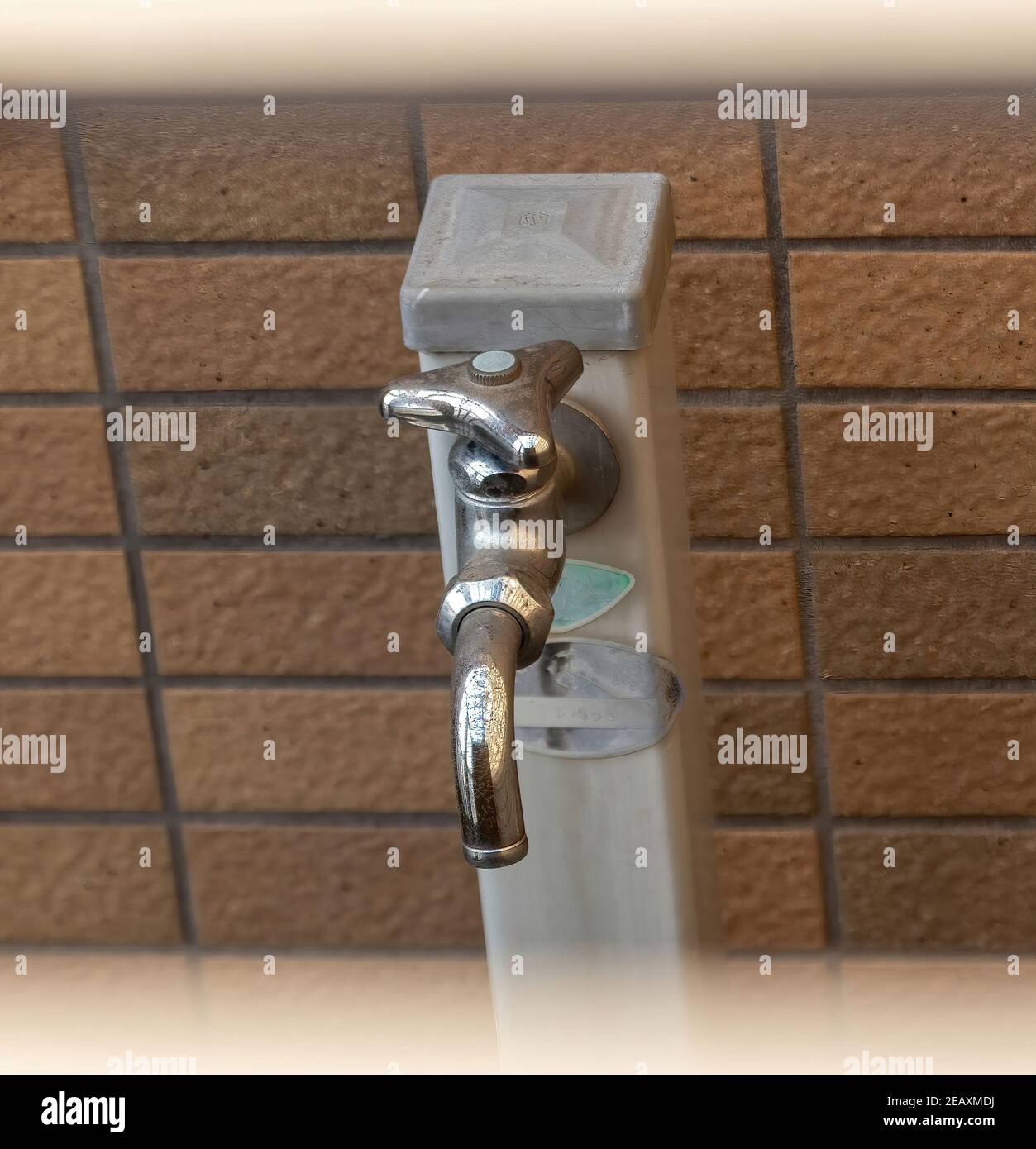Stainless steel tab, as seen through the bars above it, that protect it ...