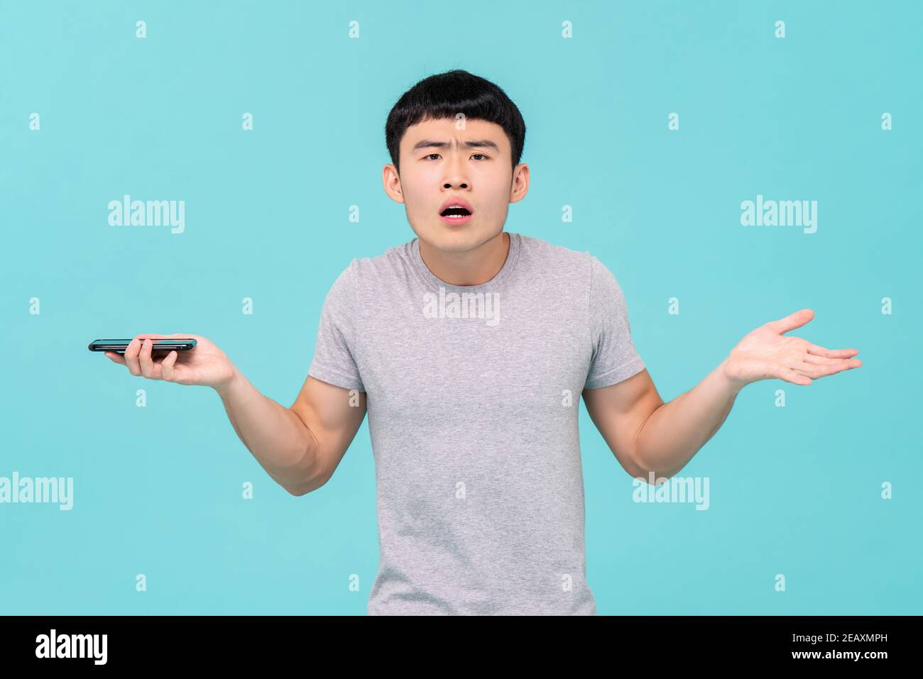 Unhappy young Asian man shrugging shoulder having trouble with his ...