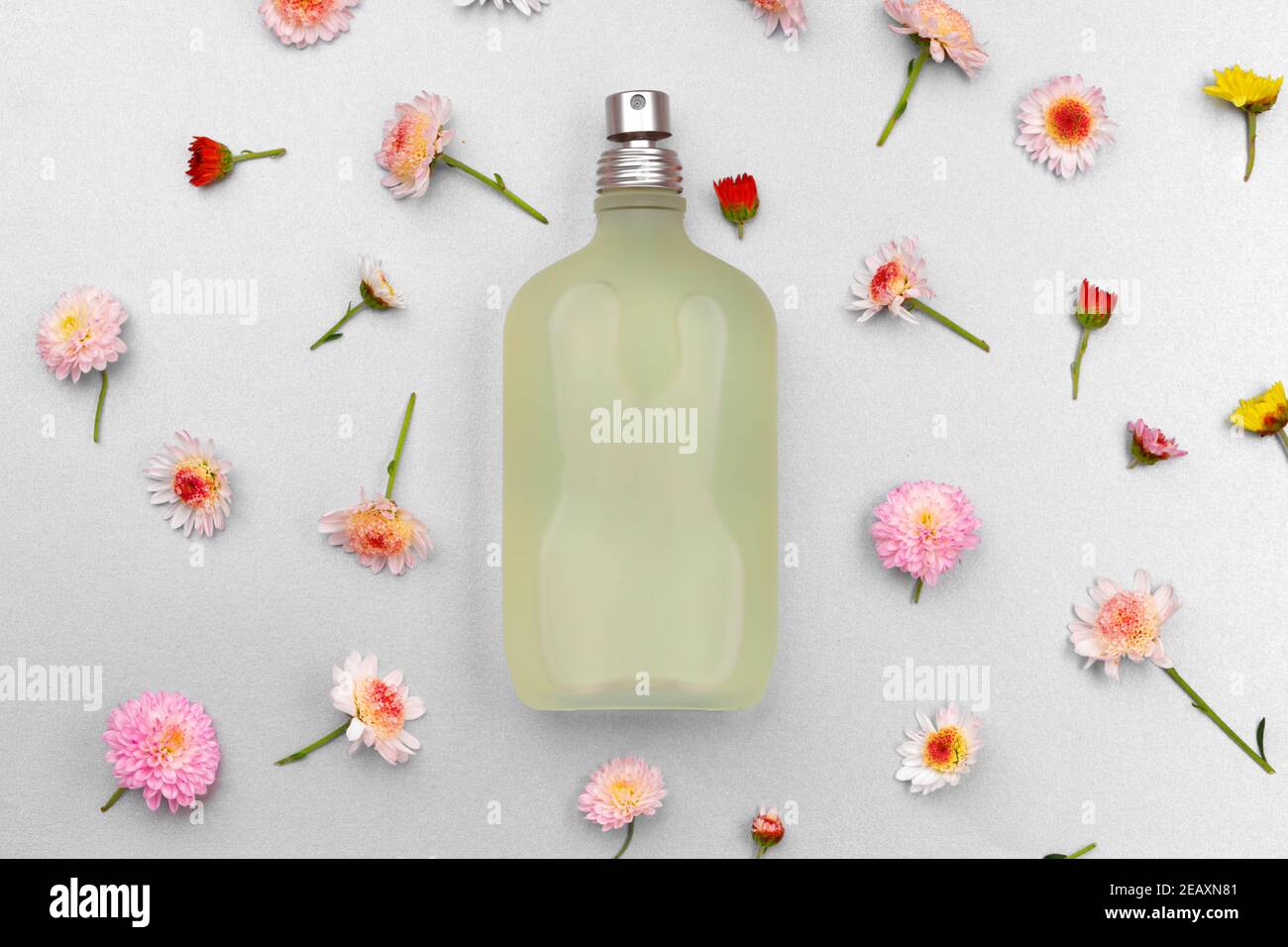 Bottle of fragrance surrounded by flower buds Stock Photo - Alamy