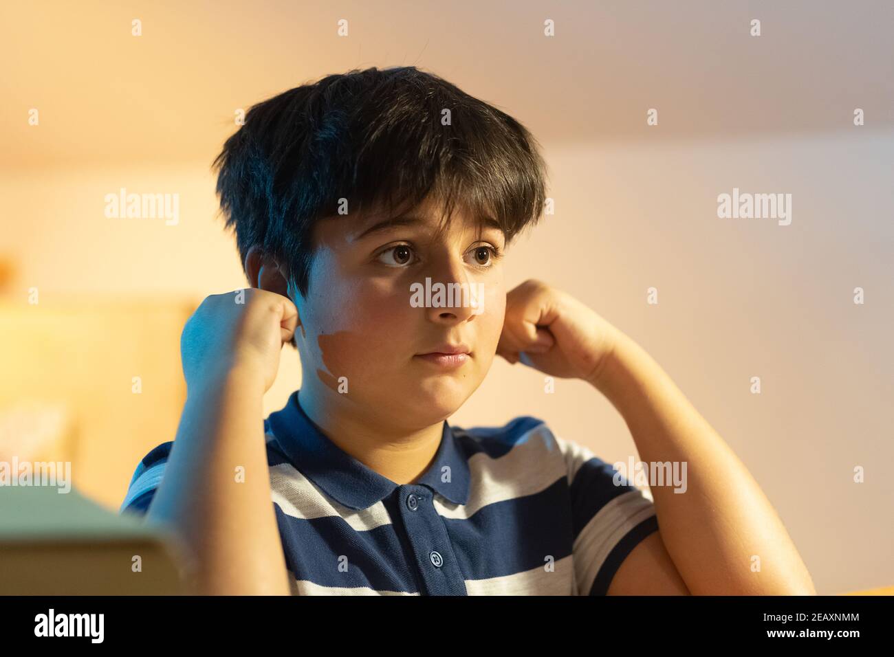 The situation of neuroses in children. boy touches his ears Stock Photo ...