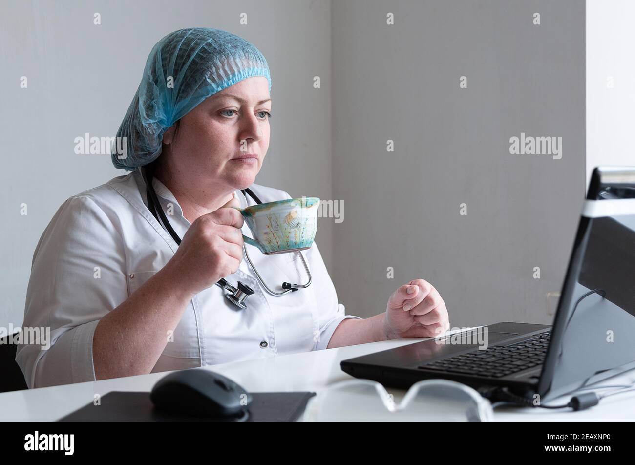 The idea of medical everyday life. Nurse in front of laptop during ...