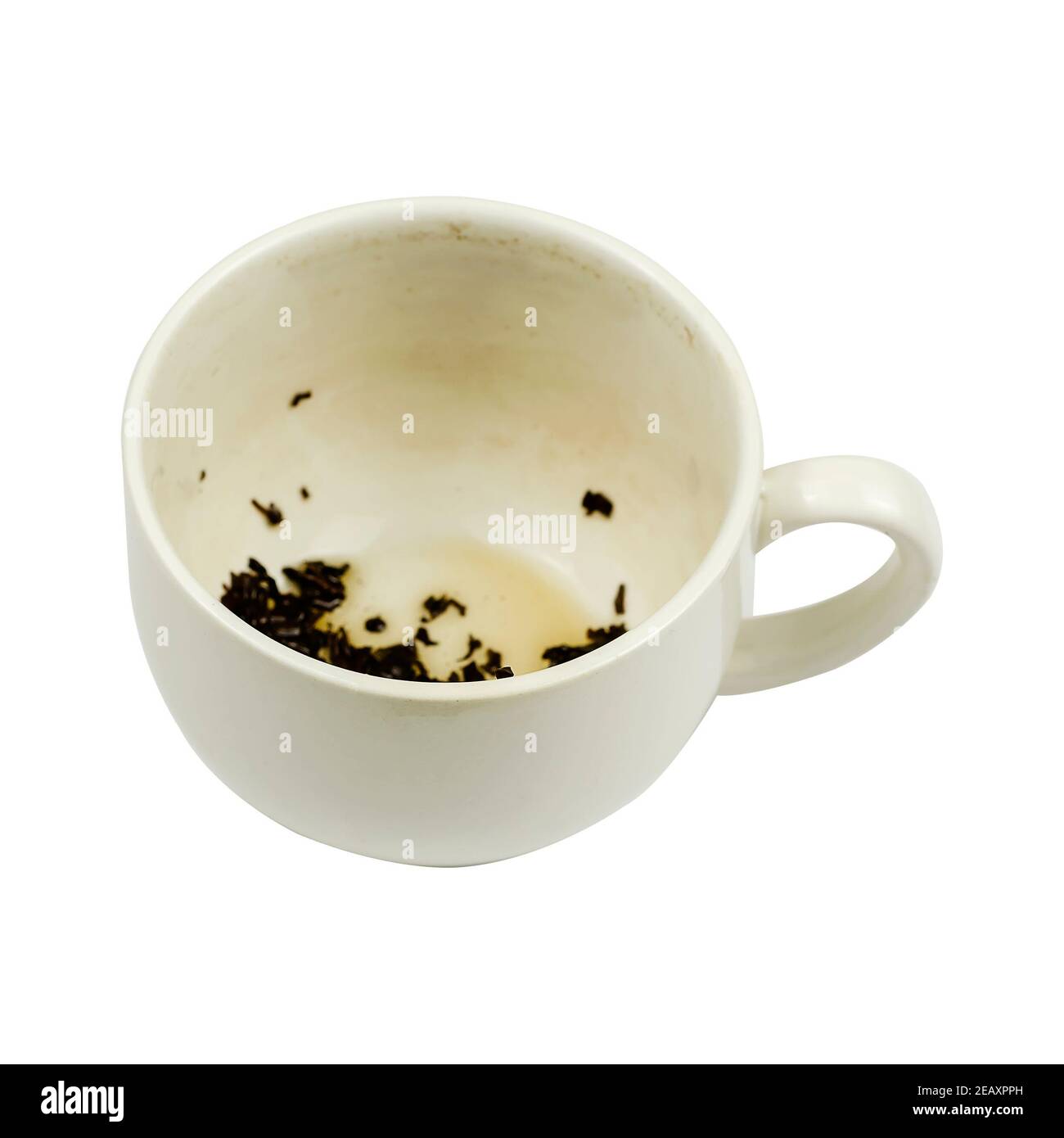 An empty dirty cup with leftover tea. White ceramic cup on a light ...