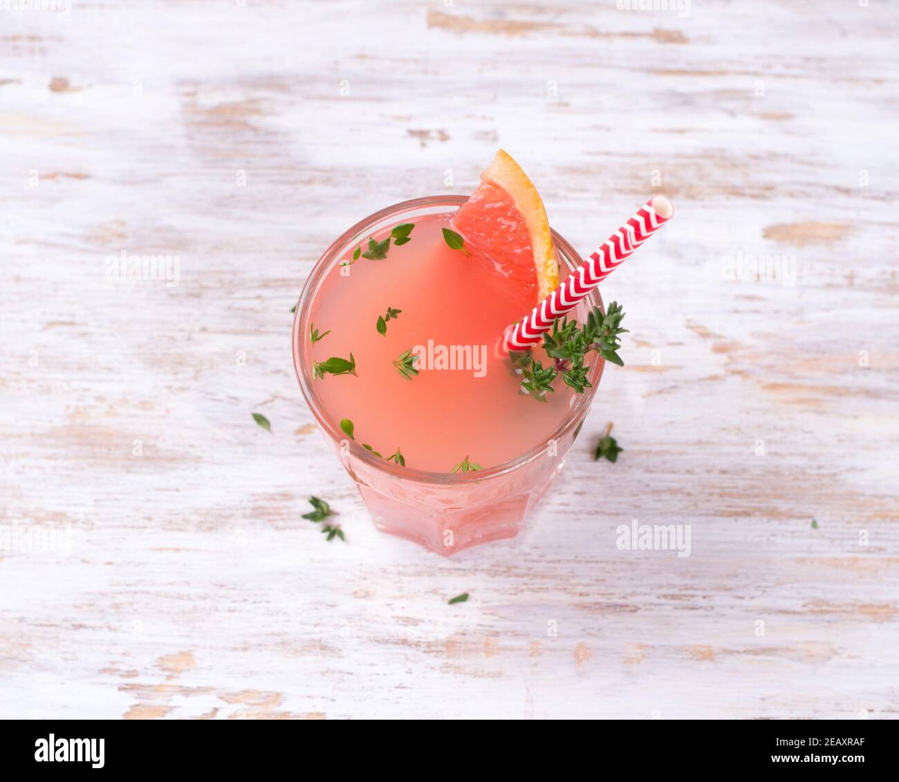 Healthy summer drink grapefruit lemonade with thyme in glasses with ice ...
