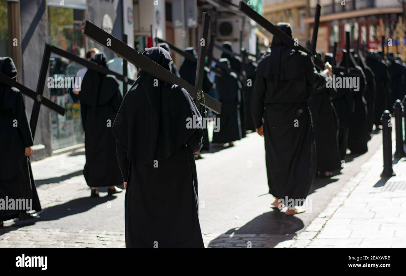 penitents with crosses in procession Stock Photo - Alamy