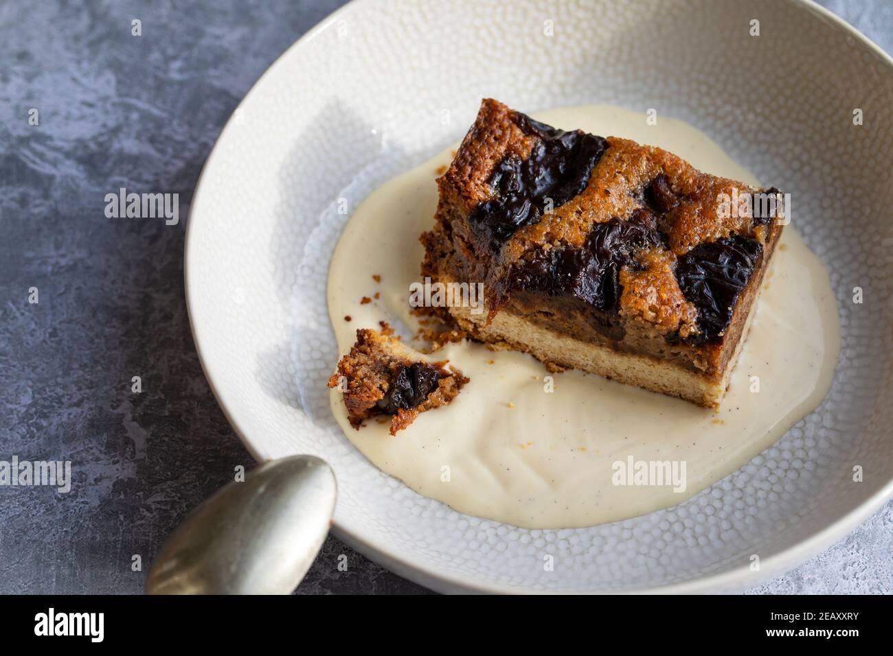 Prune and walnut cake with vanilla custard Stock Photo - Alamy