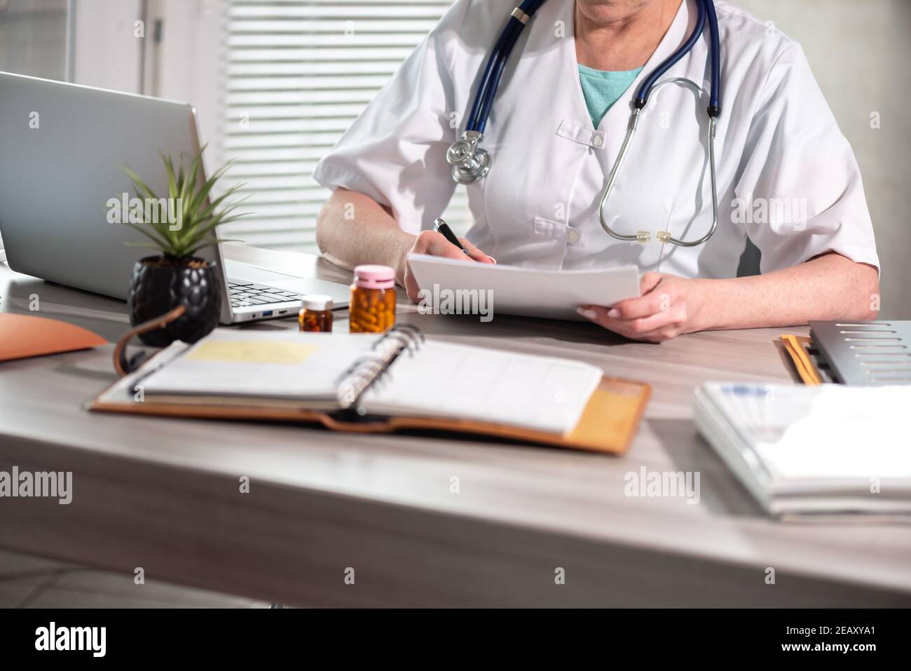 Female doctor reading medical report in medical office Stock Photo - Alamy