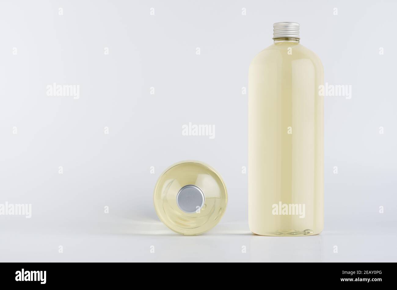 Set of two transparent plastic tall bottles standing and lying with ...