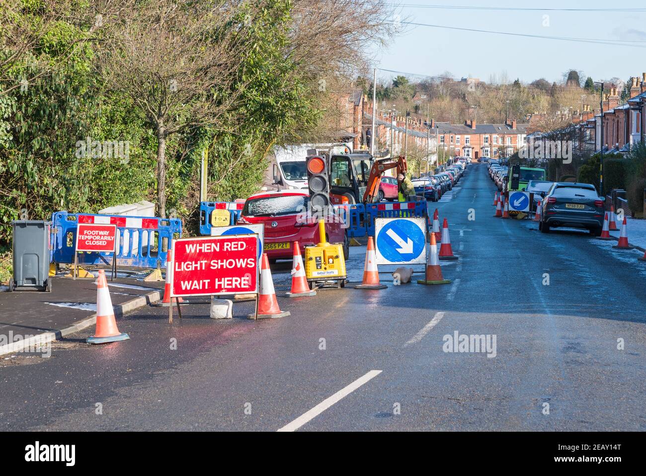 Temporary traffic lights at road works on a residential road in ...