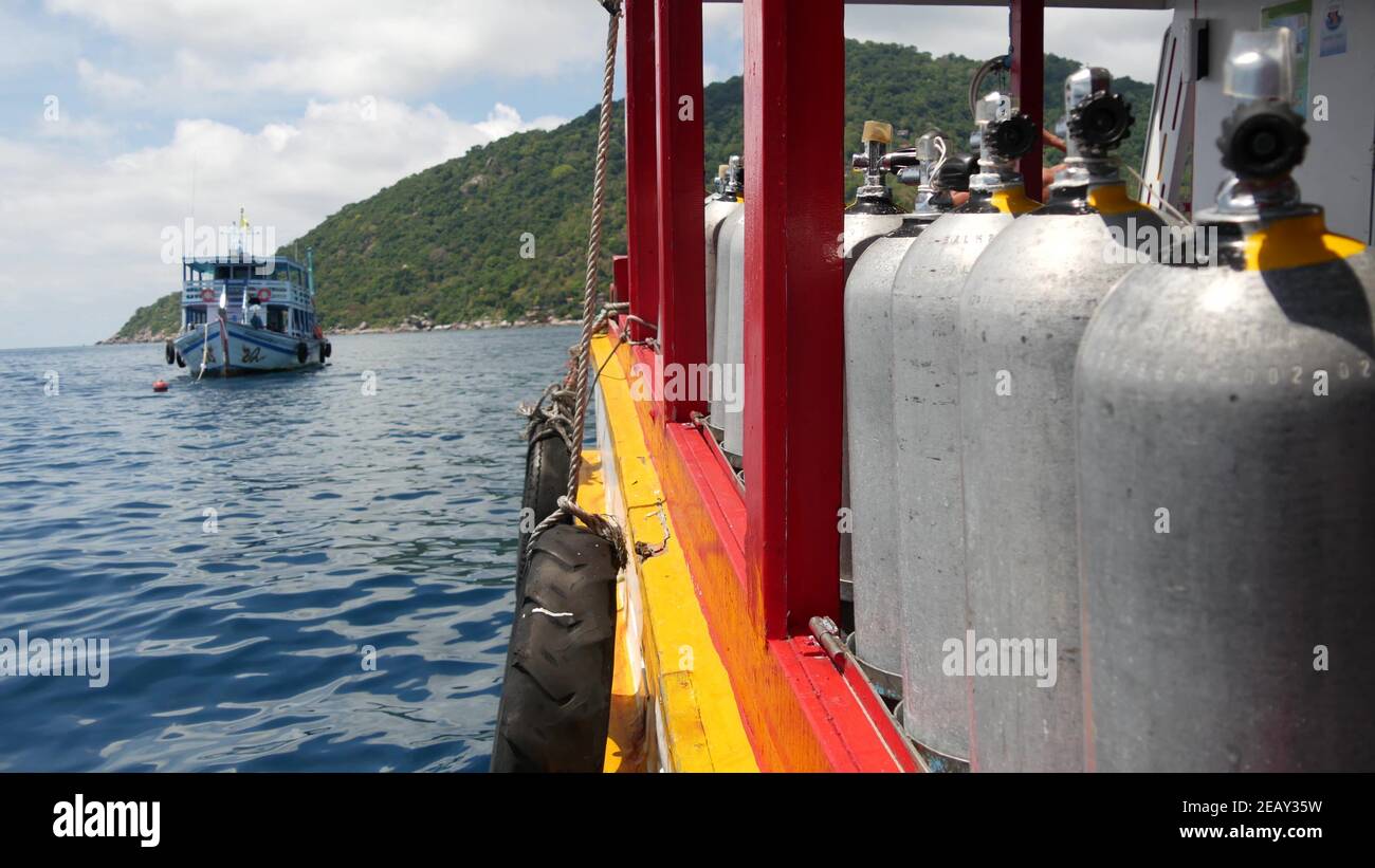 Row of oxygen tanks and diving equipment placed on modern boat in ...