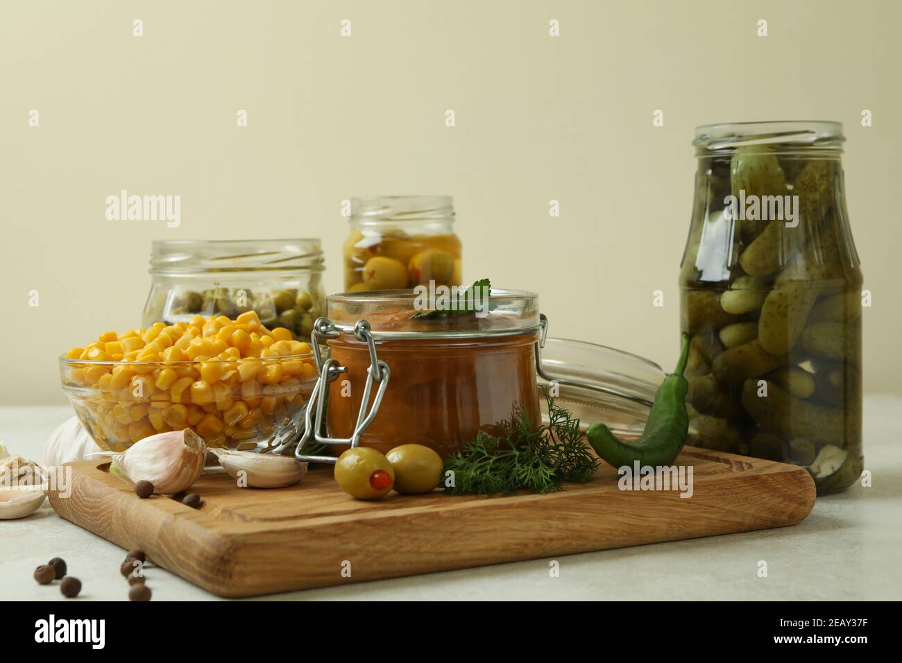 Different pickled food and ingredients on white textured table Stock ...