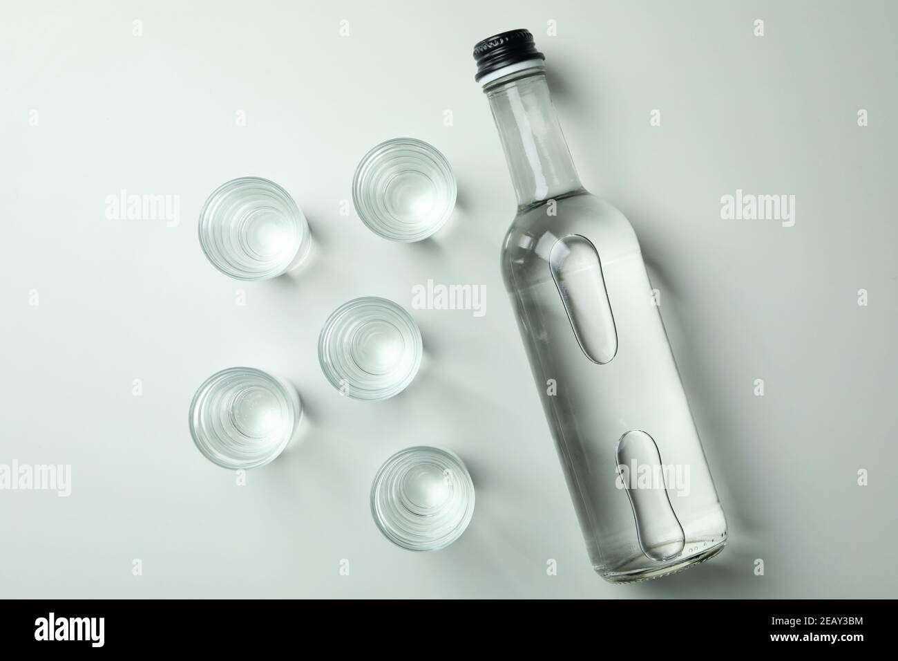 Bottle and shots of vodka on white background Stock Photo - Alamy