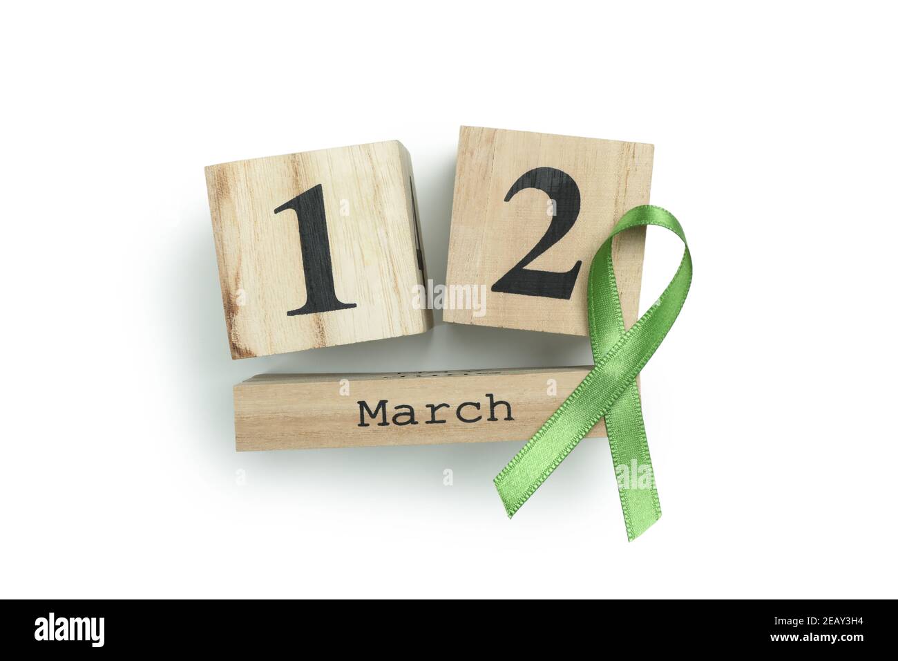 Wooden calendar with 12 march and green awareness ribbon isolated on ...