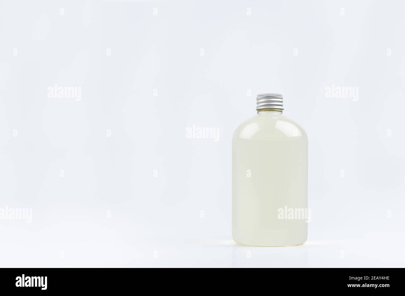Transparent plastic low thick bottle with pale fresh drink or cosmetic ...