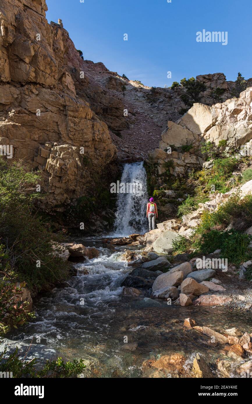 Woman hiking in the mountains against waterfall in Esquel, Patagonia ...