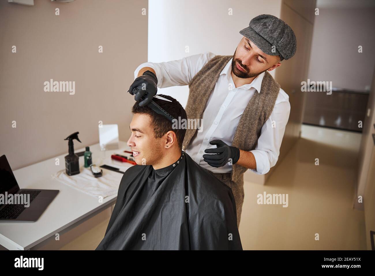 Happy smiling client getting hairdressing in room indoors Stock Photo ...