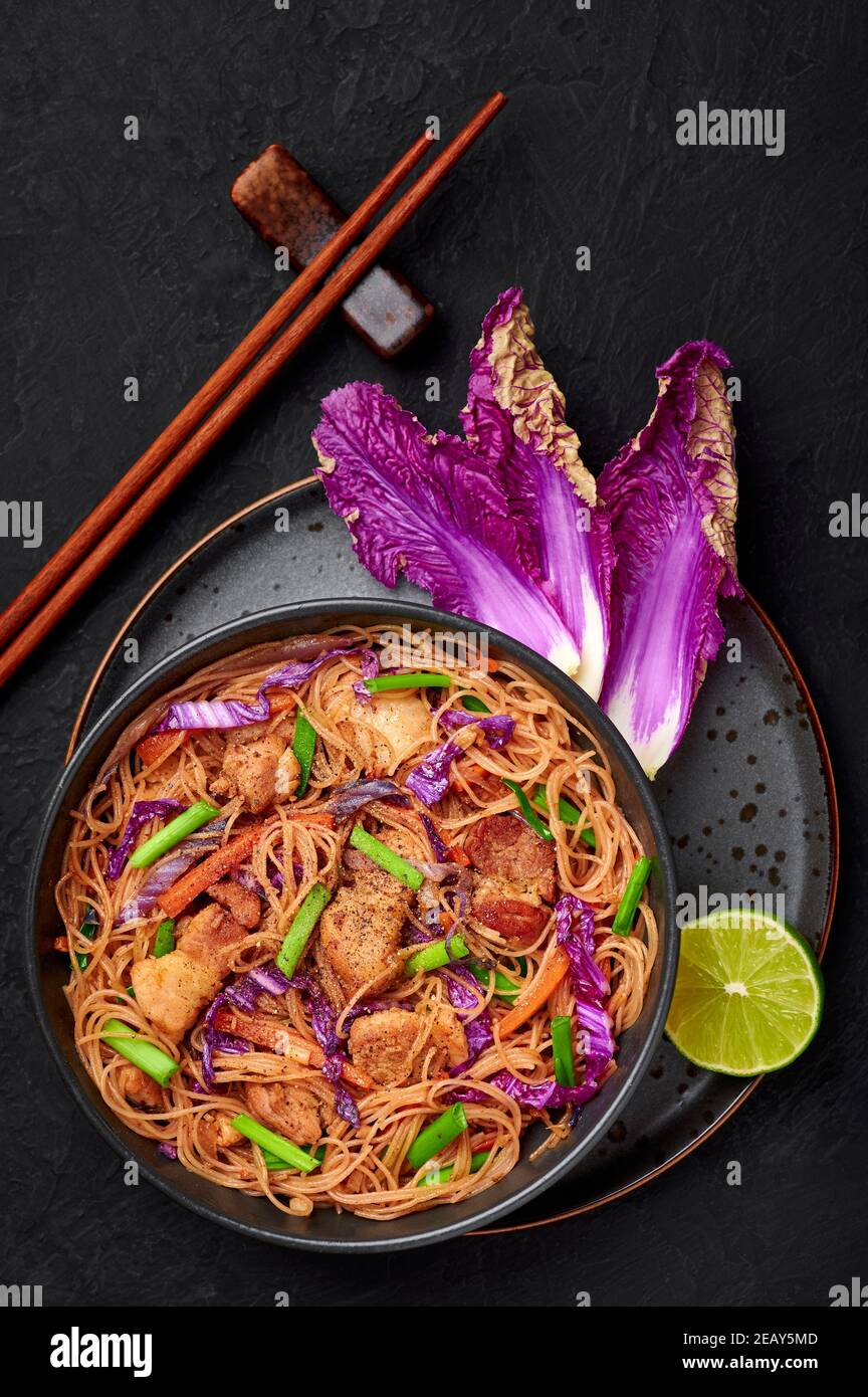 Pancit Bihon in black bowl on dark slate table top. Filipino cuisine ...