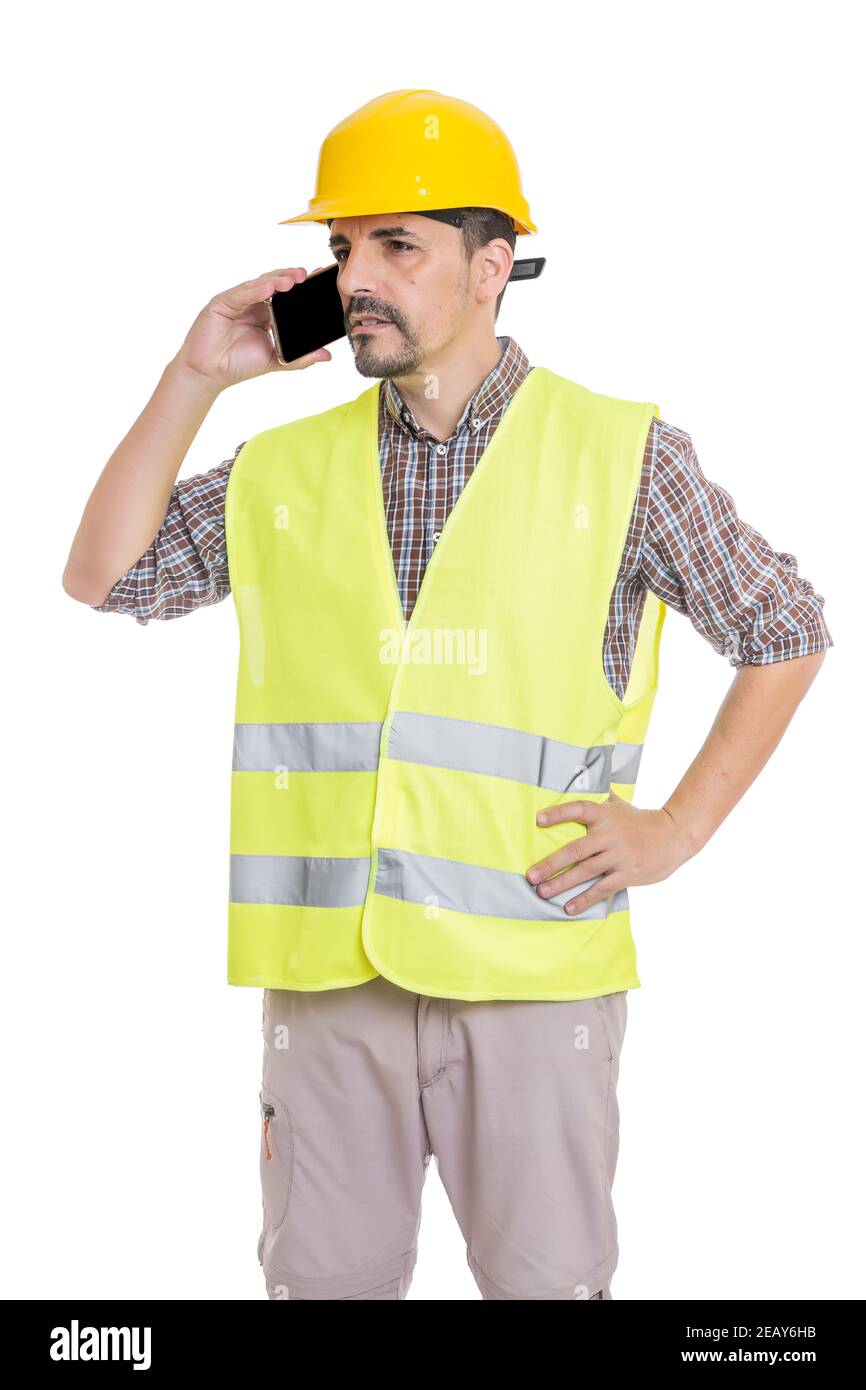 Busy male builder in yellow hardhat and reflective vest standing with ...