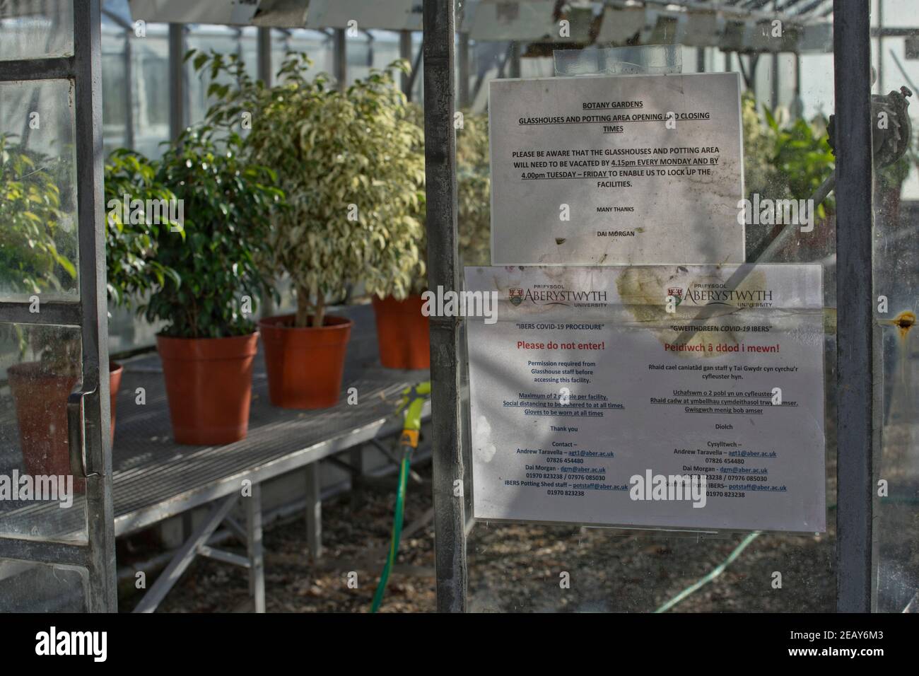 Botanical greenhouses with bilingual signs warning of Covid-19 pandemic ...