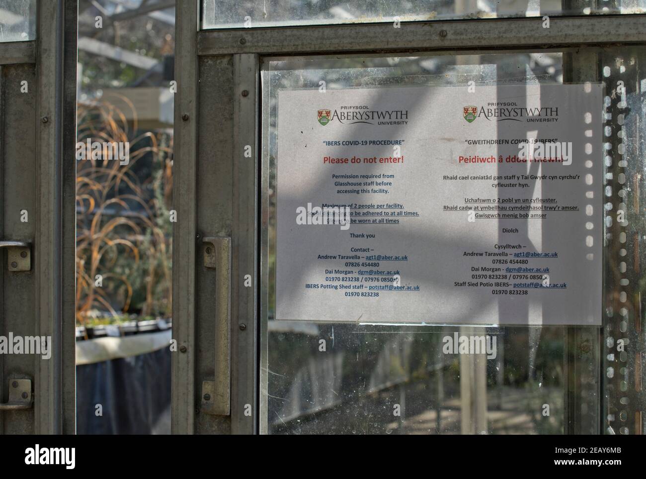 Botanical greenhouses with bilingual signs warning of Covid-19 pandemic ...