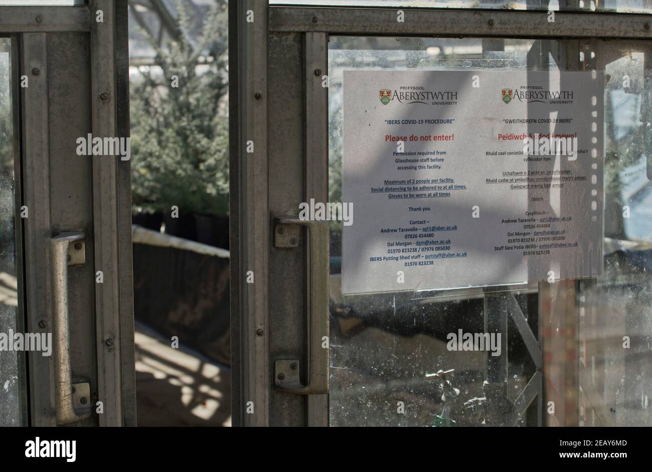 Botanical greenhouses with bilingual signs warning of Covid-19 pandemic ...