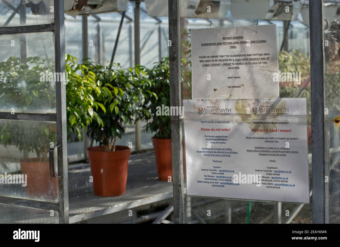 Botanical greenhouses with bilingual signs warning of Covid-19 pandemic ...