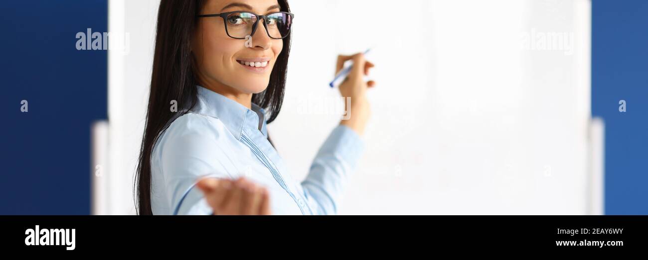 Beautiful young woman giving presentation Stock Photo - Alamy