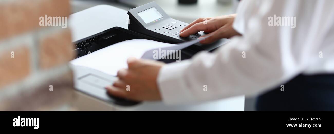 Woman in office prints documents on printer Stock Photo - Alamy