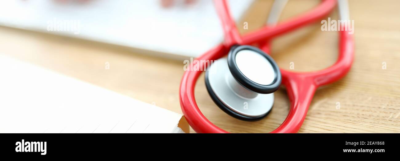 Red stethoscope is lying on table Stock Photo - Alamy