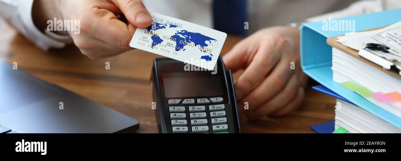 Man applies card to terminal Stock Photo - Alamy