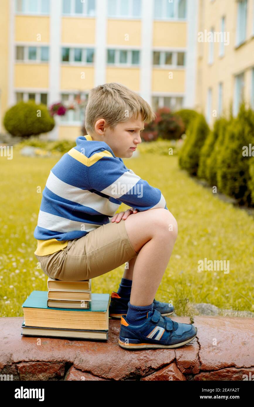 Child sitting outside with books hi-res stock photography and images ...