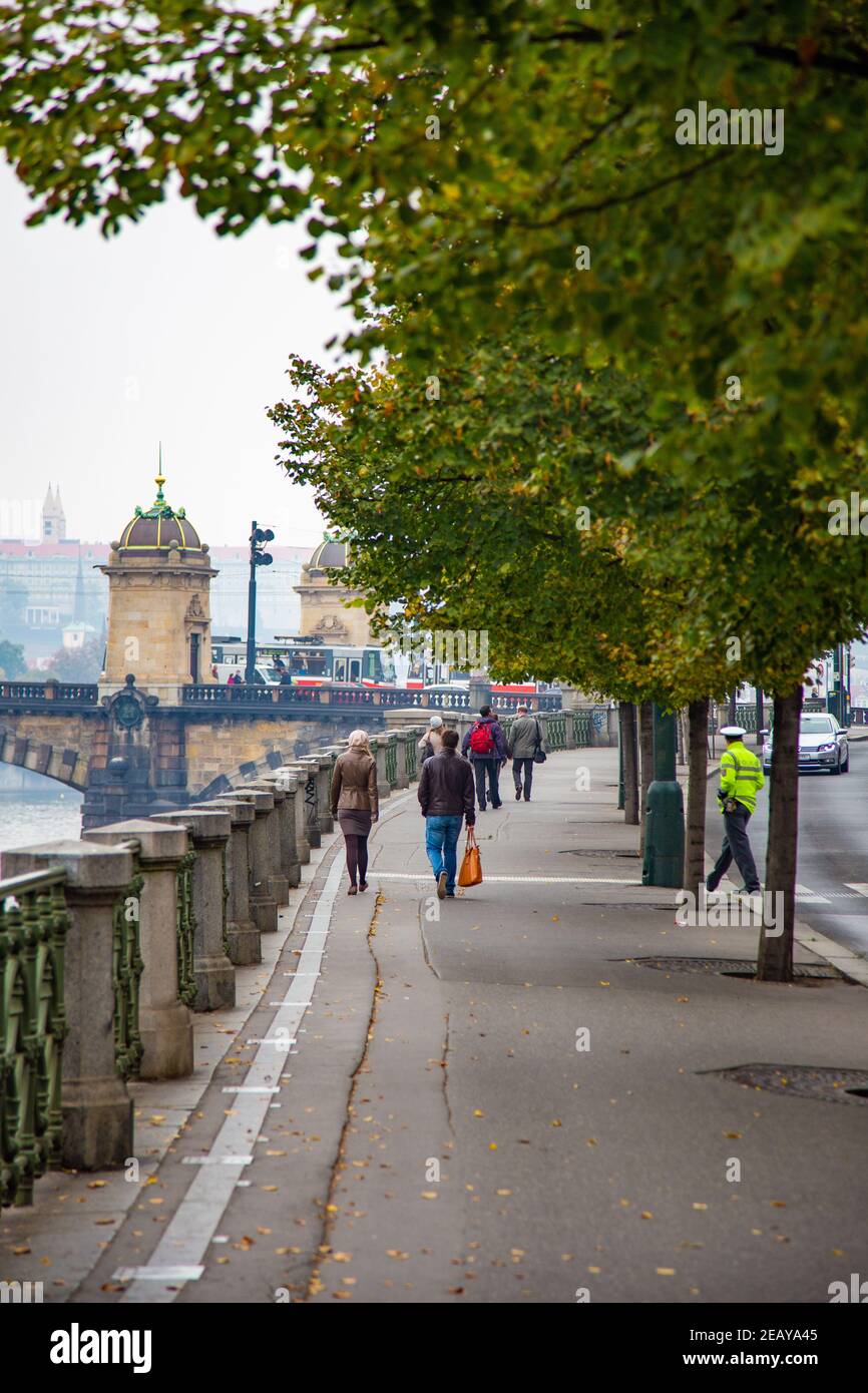 PRAGUE, CZECH REPUBLIC - Oct 09, 2013: People walking on the bank of ...