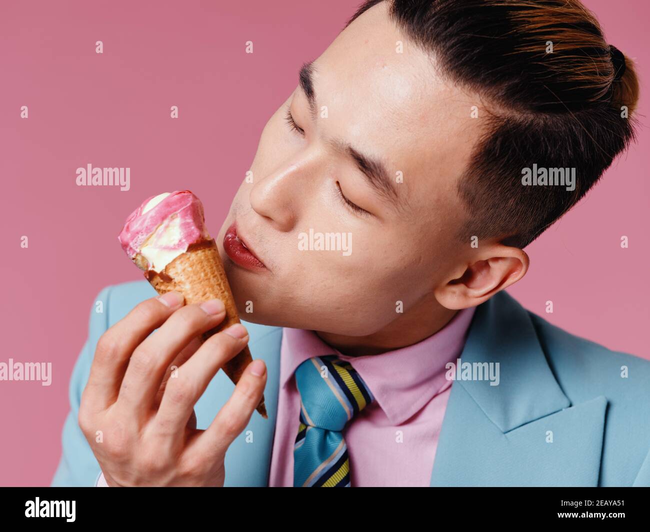 Asian man with ice cream in hand and blue jacket tie Stock Photo - Alamy