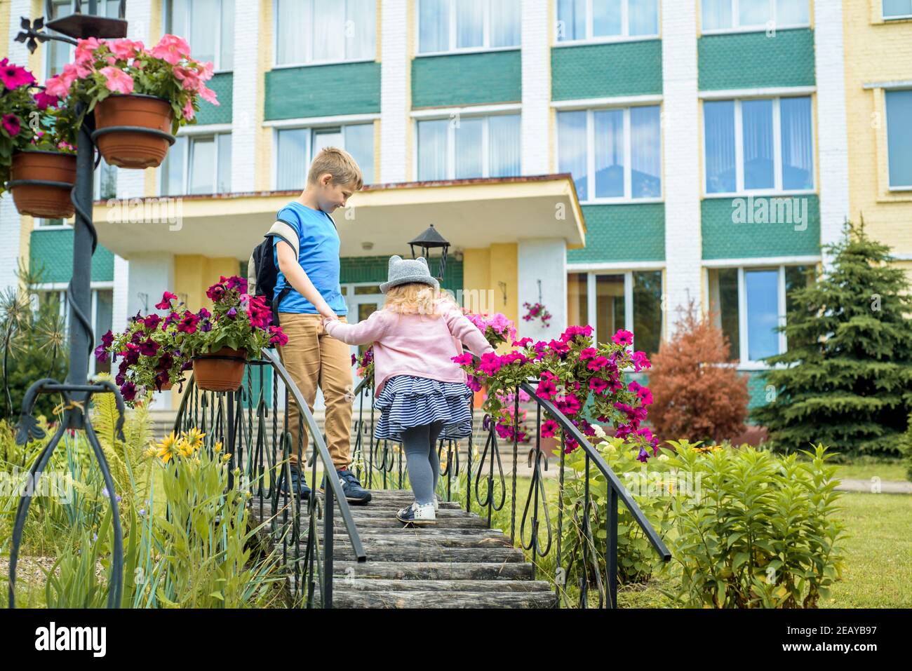 Happy children playing in the school yard at the day time.Outdoors ...